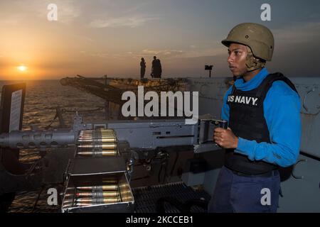 US Navy Airman mans the gun turret of a humvee while maintaining ...