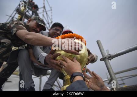 A staff of the National Reconstruction Authority carrying final gold ...