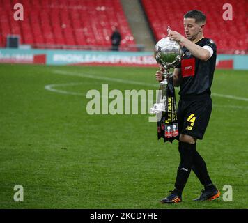 Josh Falkingham of Harrogate Town holds The Buildbase FA Trophy during ...