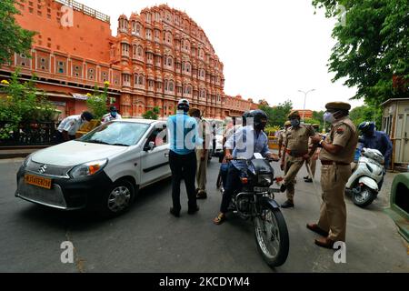 Security personnel check commuters during COVID-induced lockdown at ...