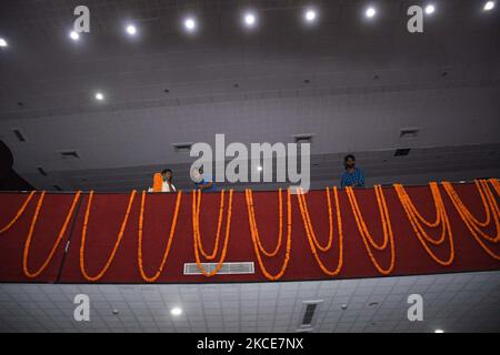 Worker decorate a Auditorium for oath taking ceremony of Chief Minister and other ministers of ...