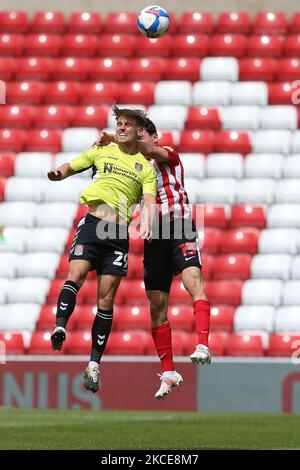 Danny Rose of Northampton Town contests a header with Sunderland's Luke ...