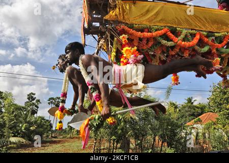 Tamil Hindu devotees perform the para-kavadi ritual while on route to ...
