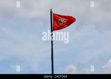 Flag with the aum symbol of Hinduism in front of the main Hindu temple ...