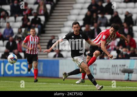 Luke O'Nien of Sunderland in action with Janoi Donacien of Fleetwood ...