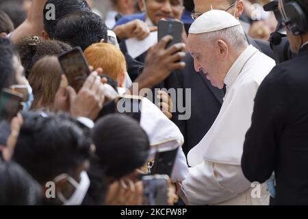 Pope Francis is greeted by faithful during the weekly general audience ...