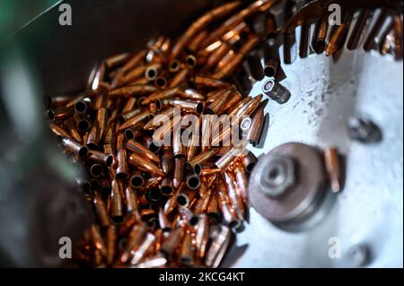 Pile of Copper bullet shells and turning wheel at production line Stock ...