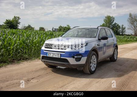 Coast guard land rover oversees air ambulance landing on beach in devon ...