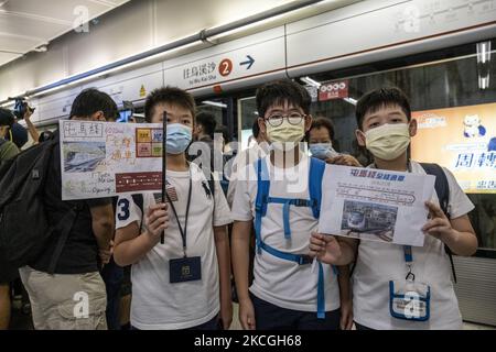 Passengers pose for a photo after riding the first train of the Tuen Ma ...