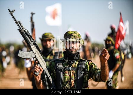 Syrian fighters march in columns, ride dirt bikes and and drive pick-up ...