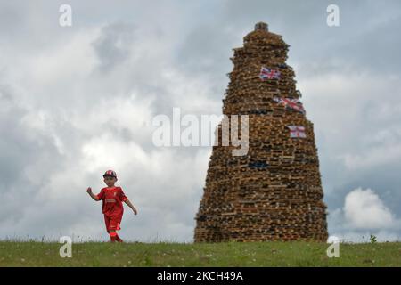 Harvey (age 3), a local kid plays near a typical loyalist bonfire ...