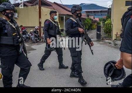 Fully armed policemen stand guard in front of the Bhayangkara Hospital ...