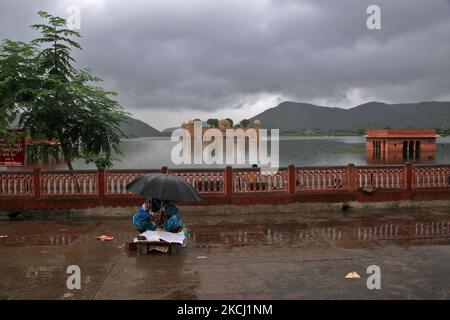 A view of 'Jal Mahal' as clouds hover over the city on a rainy day ...