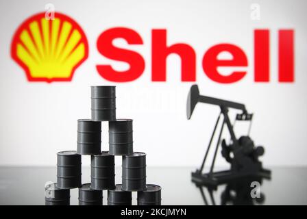 Miniature models of an oil derrick pump and oil barrels and a graph are ...