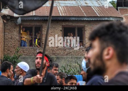Kashmiri Shiite Muslim women watch a Muharram procession in Srinagar ...