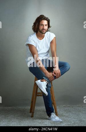 Handsome man posing against grey background Stock Photo - Alamy