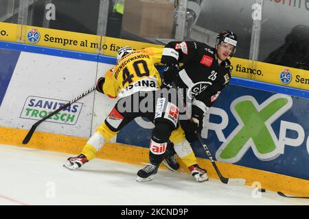 Mirco Muller #25 (HC Lugano) in a duel with Sven Senteler #88 (EV Zug ...