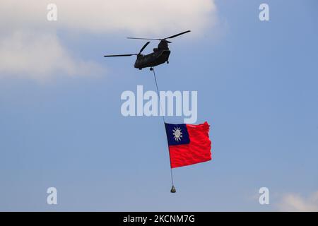 A Chinook Helicopter carrying a tremendous Taiwan flag flies over a ...