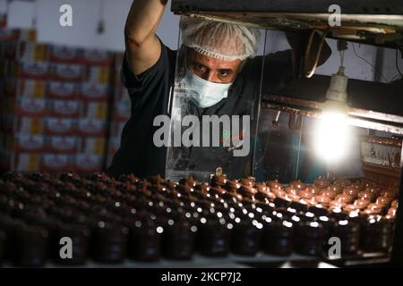 Palestinian workers prepare the vanilla candy known as "crimbo or Ras ...