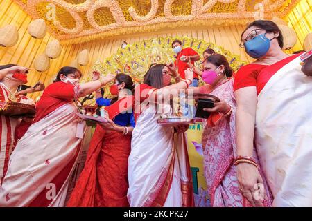 Married ladies smearing red sindur or vermilion , a ritual known as ...