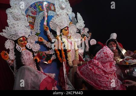Hindu devotees perform rituals at a 'pandal,' a temporary structure set ...