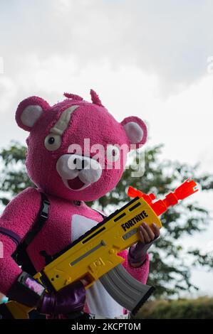 A cosplayer wears a costume of popular battle royale Game Fortnite ...