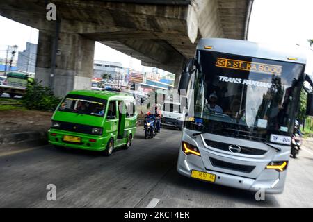 A Kita Trans Pakuan bus drives on a main road in Bogor, Indonesia on ...