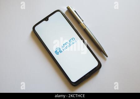 In this photo illustration an Applied Materials logo seen displayed on ...