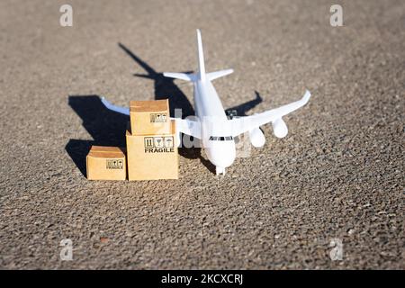 Toy airplane and tiny delivery boxes placed on the sidewalk Stock Photo ...