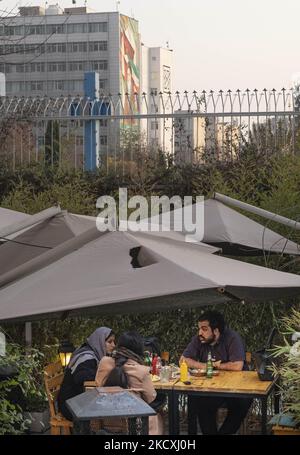 Iranian youths sit together in a cafe in downtown Tehran on December 9 ...