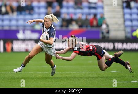 England's Tara-Jane Stanley (left) is tackled by Canada's Petra Woods ...