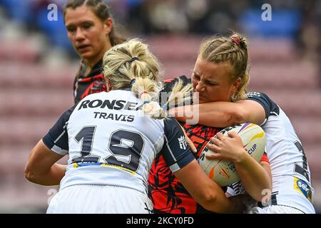 Rachel Chaboter of Canada is tackled by Vicky Molyneux and Paige Travis ...