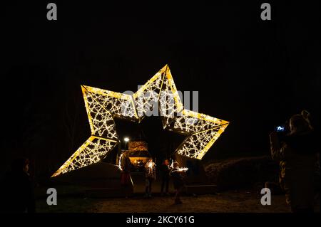 Real Santa Claus is playing with children near the Christmas tree. The ...