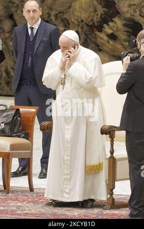Pope Francis talks on the phone during his weekly general audience in ...