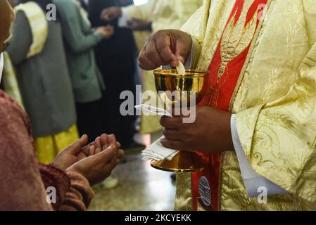 GUWAHATI,INDIA- DECEMBER 25: Priest and believer are seen at a ...