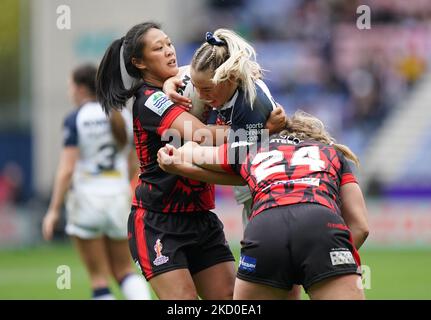 England's Hollie-Mae Dodd (centre) is tackled by Canada's Gabrielle ...