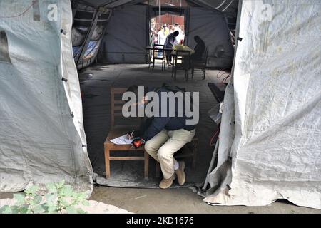 A man fills a form at a sample collection booth to get tested for the ...