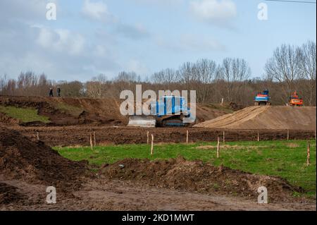 A view of a crane removing the ground placed around the second part of ...