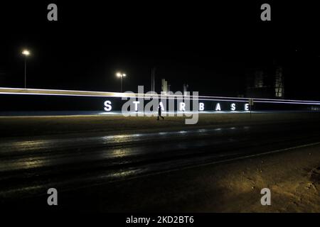 A man walks past the Starbase sign at SpaceX's South Texas campus late ...
