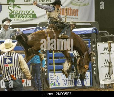 Jake Clark of Crane, Oregon, USA rides in the saddle bronc competition ...