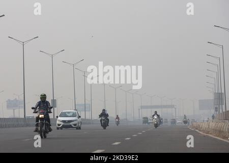 People commute along a road amid smog in Chiang Mai. Air pollution is a ...