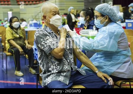 People receive doses of the Pfizer COVID-19 vaccine at a vaccination ...