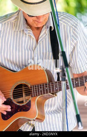 Close-up, a man plays an acoustic guitar in the autumn forest Stock ...