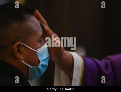 Cardinal Álvaro Ramazzini makes the sign of the cross with ashes on the ...