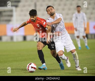 Osamah Al Tairi (16) of Al Rayyan fouls Amjad Attwan (99) of Al Shamal ...