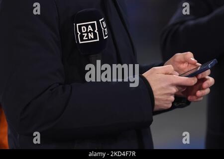 DAZN branded microphone is held by a pitchside commentator prior to ...