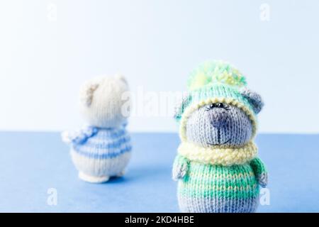 Knitted toys. A plush bears knitted from threads in decorative clothes ...