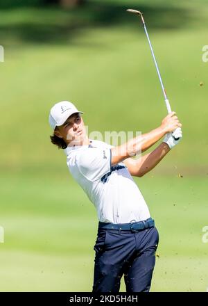 Harrison Crowe (A) of Australia plays his 2nd shot on the 1st hole ...
