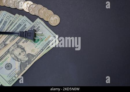 dollar bills and coins with an electric plug. expensive energy Stock ...