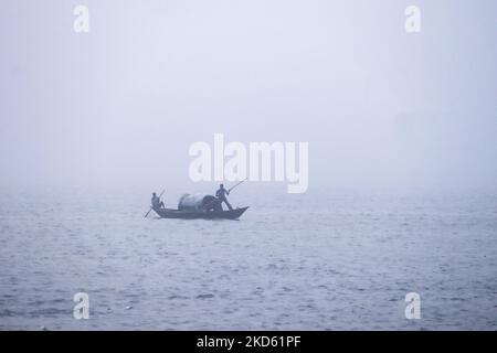 Fishermen paddle their boat during a sand storm in the Brahmaputra ...